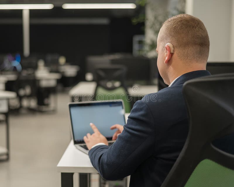 Caucasian Deaf Man Typing on Laptop in Office. Stock Image - Image of ...