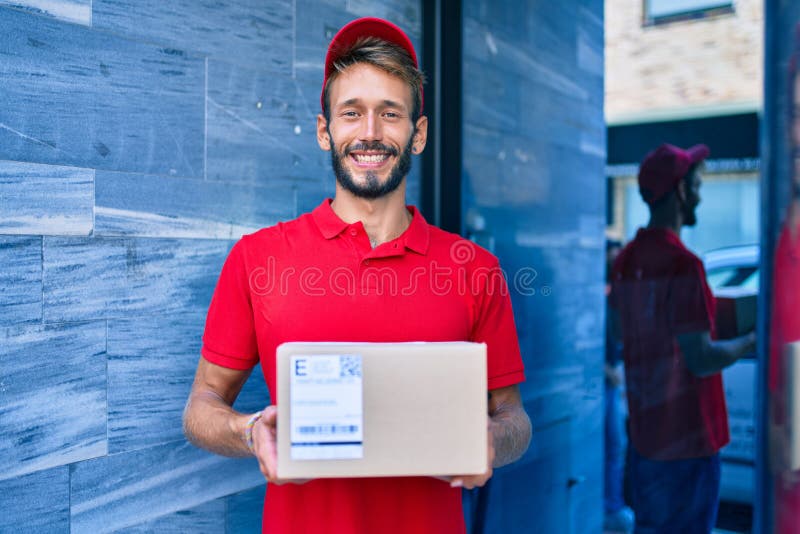 Caucasian Delivery Man Wearing Red Uniform and Delivering Parcel Stock ...