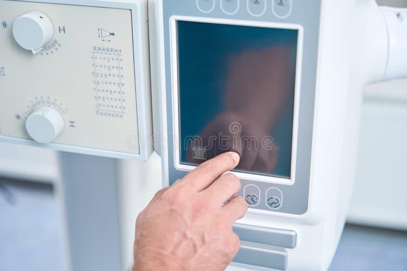 Caucasian Doctor Adjusting the Touch Panel of the X-ray Machine Stock ...