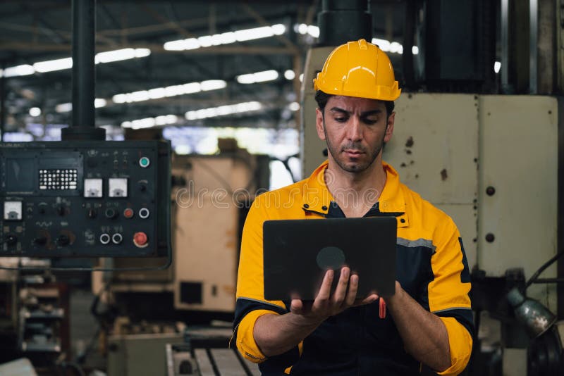 Caucasian Engineer Using a Laptop in a Factory. Man Working in Plastics ...
