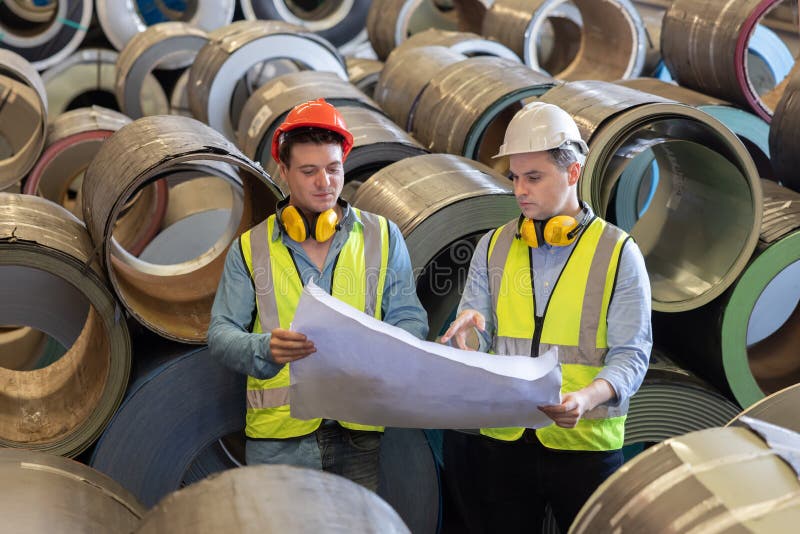 Caucasian Factory Workers Planning Their Work with Blueprint Paper in ...