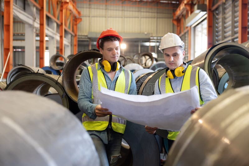 Caucasian Factory Workers Planning Their Work with Blueprint Paper in ...