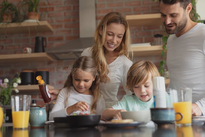 Caucasian Family Having Food at Dining Table Stock Image - Image of ...