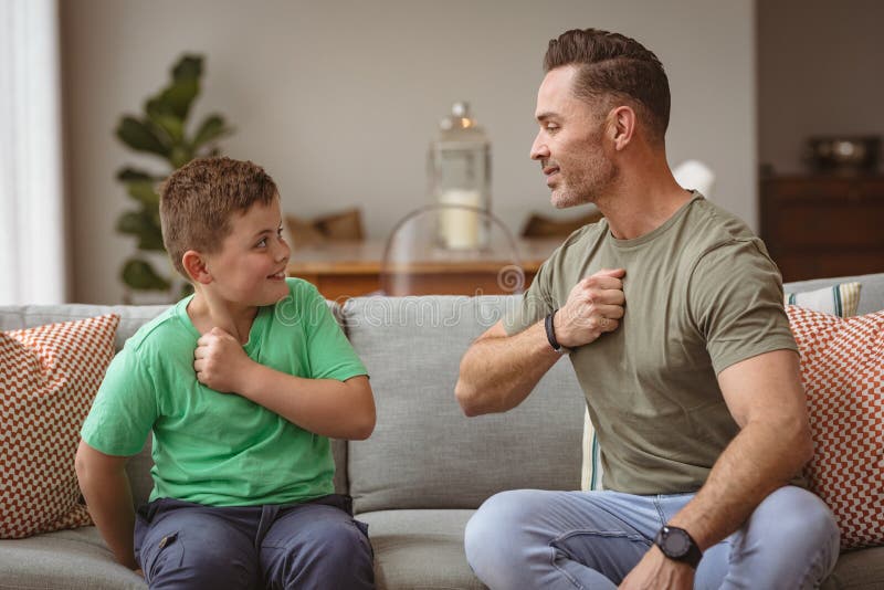 Caucasian Father and Son Communicating Using Sign Language while ...