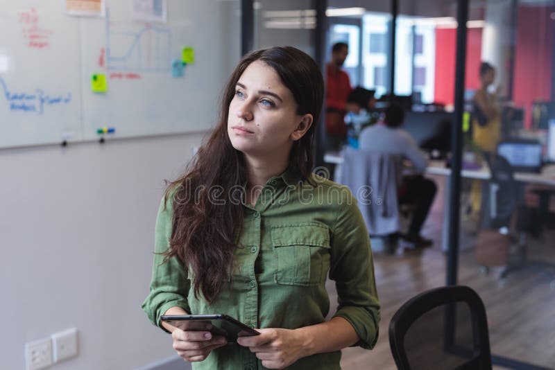 Caucasian Female Creative Worker Using Tablet Computer and Looking Away ...