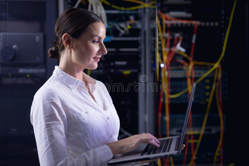 Caucasian Female Engineer Using Laptop in Computer Server Room Stock ...