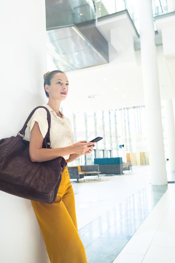 Caucasian Female Executive Looking Away while Standing in Modern Office ...