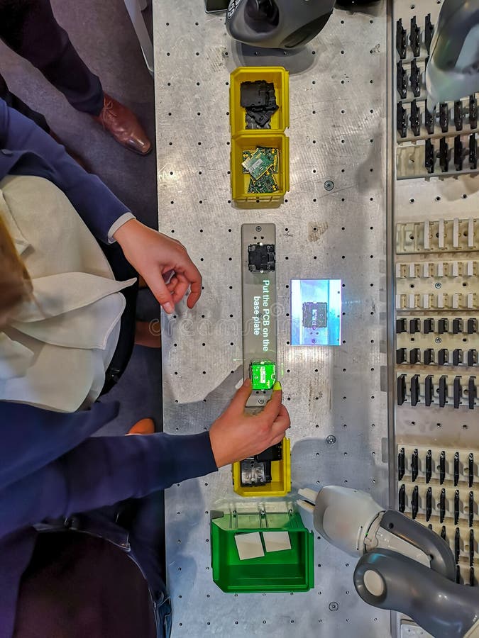 Caucasian Female Operator Standing at an Assembly Workstation with a ...