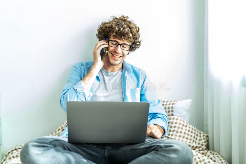 Caucasian Freelancer Guy Talking on Phone Using Laptop Computer ...