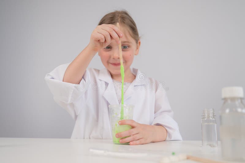 Caucasian Girl Doing Chemical Experiments on a White Background. Making ...