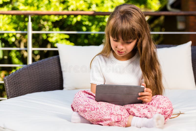 Girl with tablet stock image. Image of reading, children - 41592371