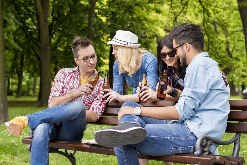 Caucasian Group of Friends Hanging Out and Drinking Beer on a Park ...