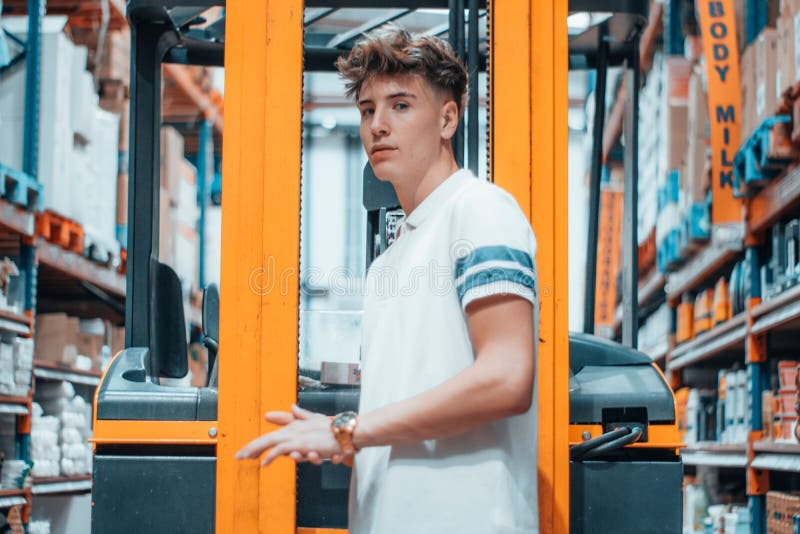 Caucasian Guy Standing on a Loader Inside a Stock Store and Looking To ...