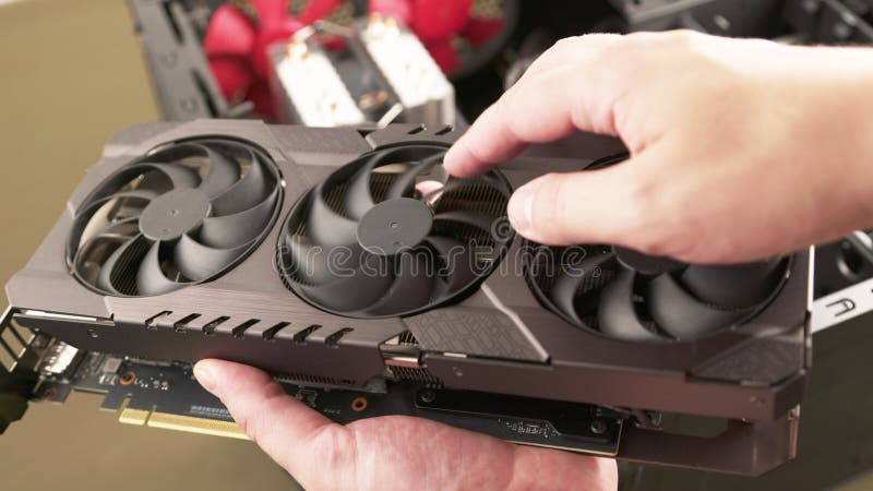 Caucasian Hands Spinning Fans of Large Air Cooled Computer Graphic Card ...