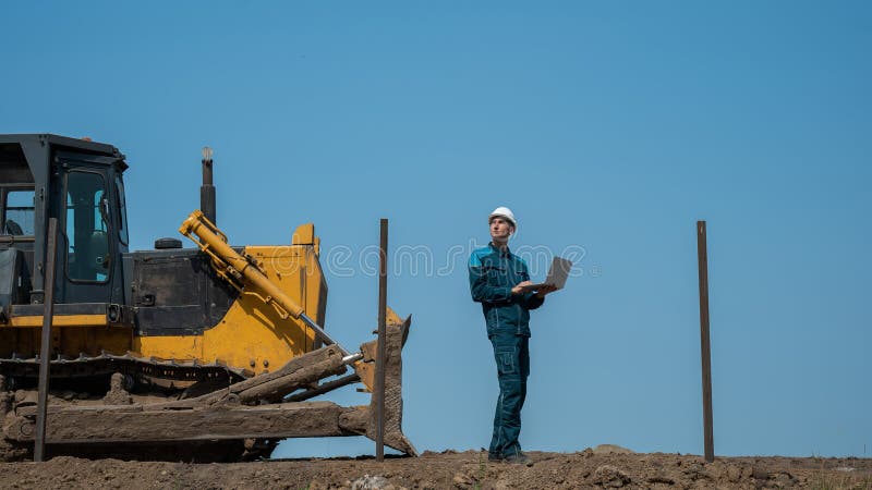 Caucasian Male Builder in Hardhat Holding Laptop at Construction Site ...