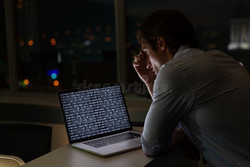 Caucasian Male Programmer Sitting At Desk Using Laptop With Coding On