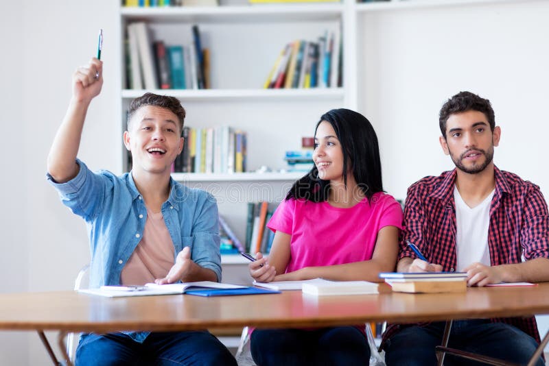 Caucasian Male Student Raising Hand in Classroom Stock Image - Image of ...