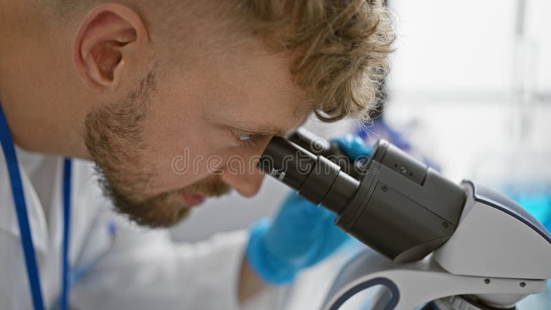 Caucasian Man with Beard Using Microscope in Laboratory Setting Stock ...