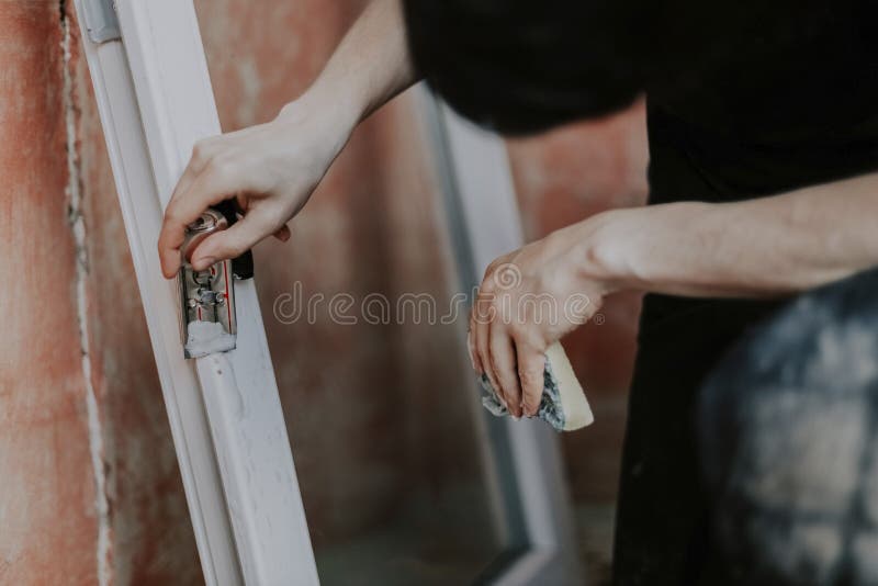 Caucasian Man Cleans a Window Frame with a Construction Knife. Stock ...