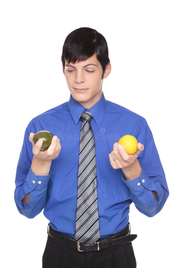 Caucasian Man Comparing Lime To Lemon Stock Image - Image of male ...