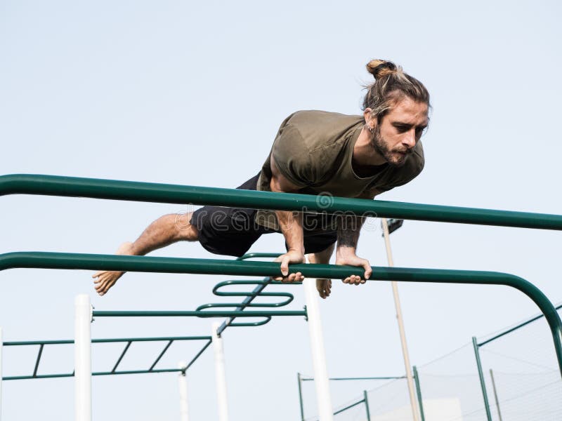 Caucasian Man Doing Elbow Lever in the Calisthenics Park Stock Image ...