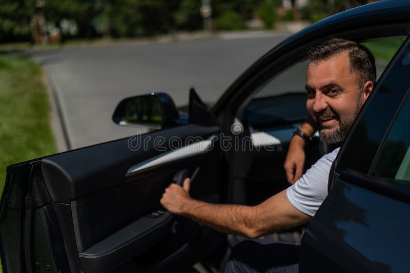 Caucasian Man Driving a Modern Electric Car. Stock Photo - Image of ...