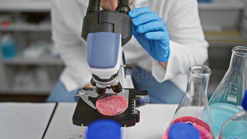 Caucasian Man Examines Synthetic Meat Under Microscope in Modern ...