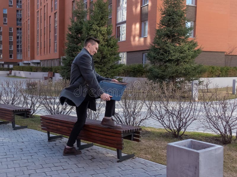 Caucasian Man Freaks Out and Breaks Laptop Outdoors. Stock Photo ...