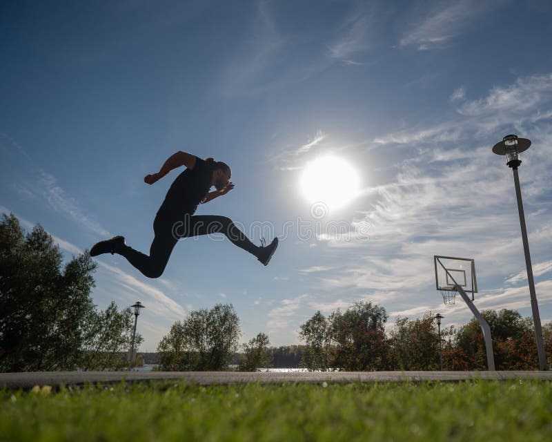 Caucasian Man Jumping with High Hip Raise Outdoors. Stock Image - Image ...