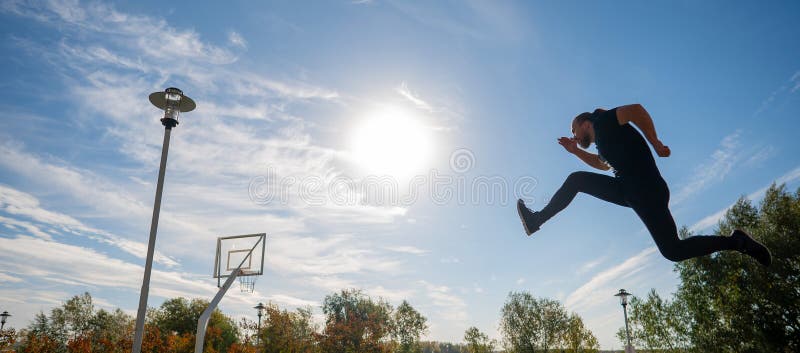 Caucasian Man Jumping with High Hip Raise Outdoors. Stock Photo - Image ...
