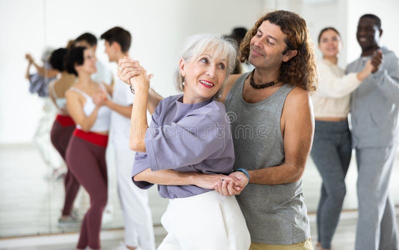 Caucasian Man and Mature Woman Rehearsing Latin Paired Dance Moves ... Caucasian Man and Mature Woman Rehearsing Latin Paired Dance Moves ...