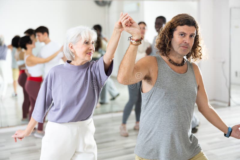 Caucasian Man and Mature Woman Learning Paired Latin Dances Stock Photo ... Caucasian Man and Mature Woman Learning Paired Latin Dances Stock Photo ...