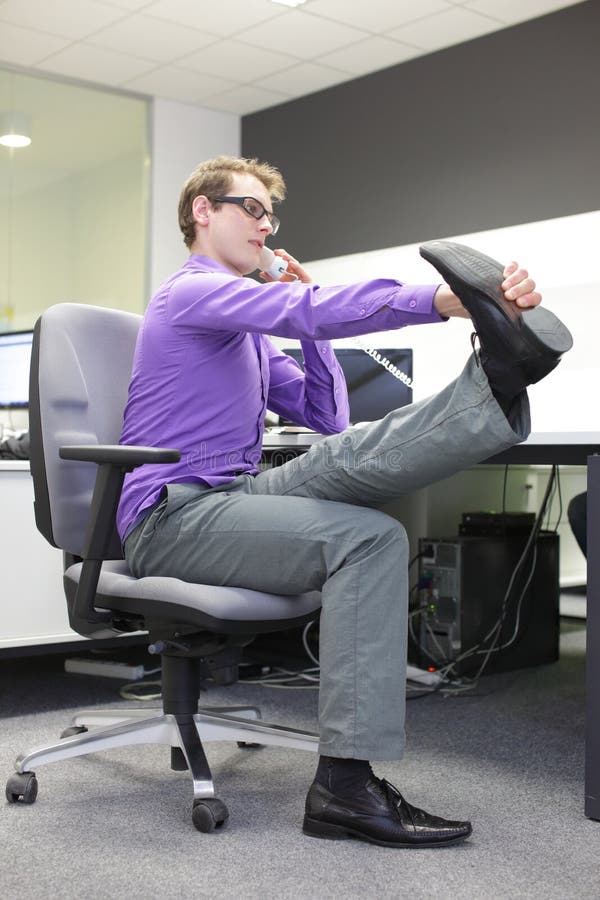 Caucasian Man Office Worker with Phone in Hand, Stretching Legs Stock ...