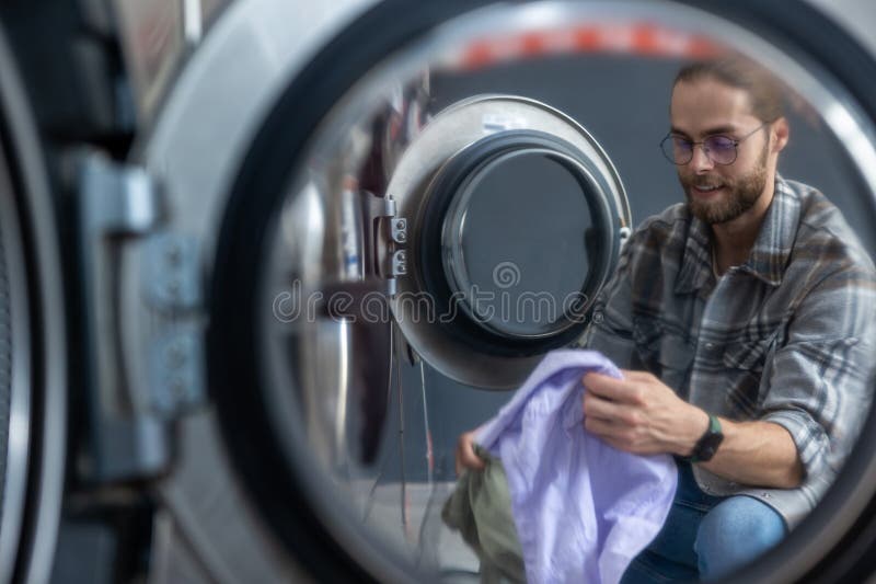 Caucasian Man Operating Washing Machine at Commercial Laundry Stock ...