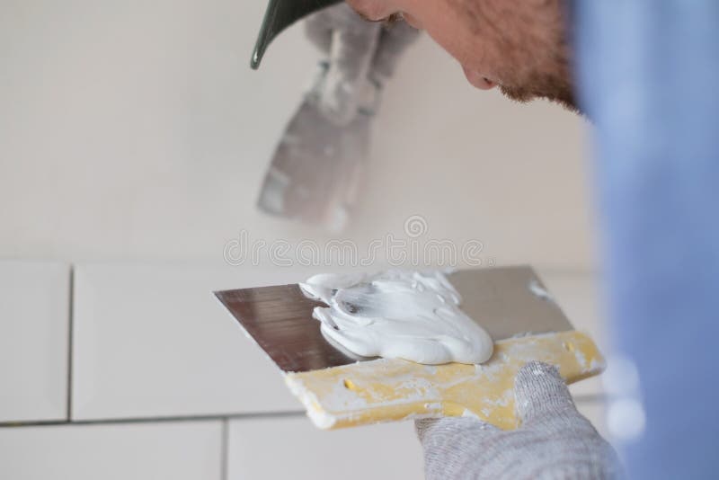 Caucasian Man Put Plaster Patching Up the Cracks on the Wall. Stock ...
