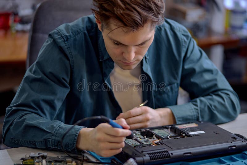 Confident Serious Male Repairing Parts in Disassembled Laptop Using ...