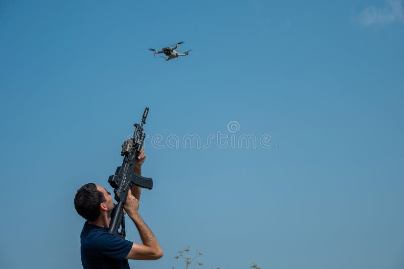 Caucasian Man Shoots a Flying Drone with a Rifle. Stock Image - Image ...