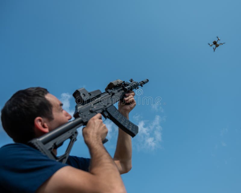Caucasian Man Shoots a Flying Drone with a Rifle. Stock Image - Image ...