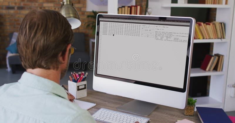 Caucasian Man Sitting at Desk Watching Coding Data Processing on ...