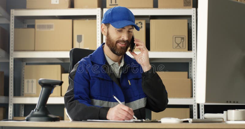 Caucasian Man Talking on Mobile Phone while Working at Post Office ...
