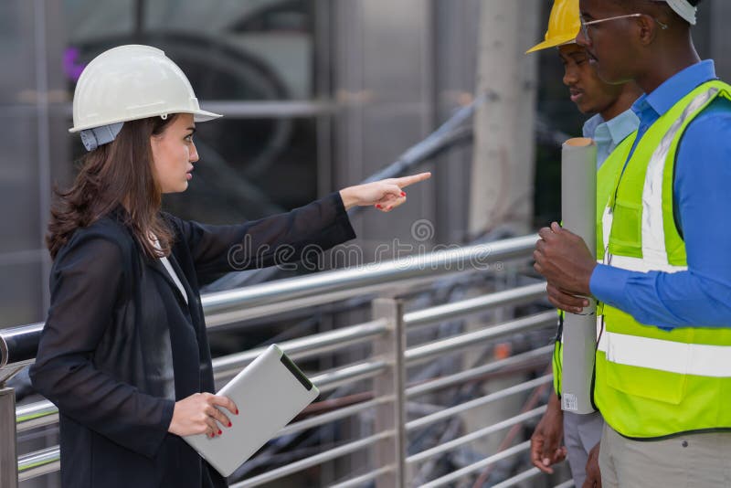 Caucasian Manager Woman In Black Suit Angry Black Engineer About Work