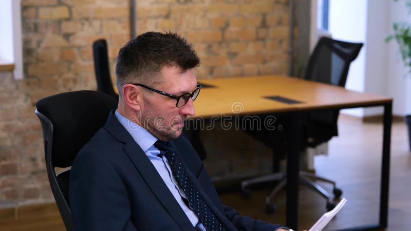 Video. Caucasian Middle Age Man S Sitting on the Table in Front of ...
