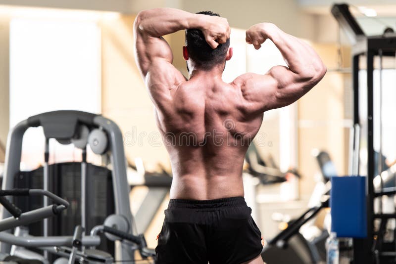 Caucasian Muscular Athletic Bodybuilder Flexing Back Muscles and ...