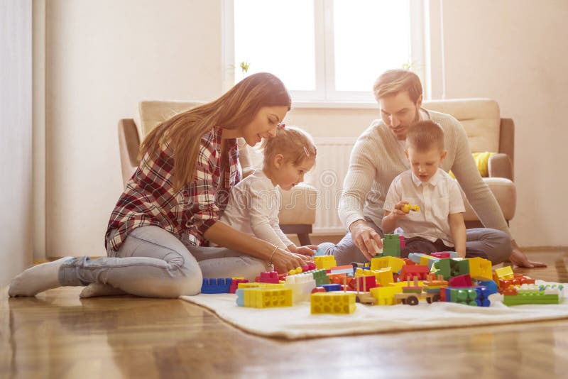 Caucasian Parents Playing with Their Children at Home Stock Photo ...