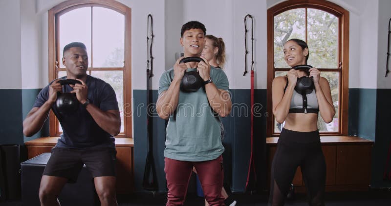 Caucasian Personal Trainer Doing Squat and Weight Training Group Stock ...