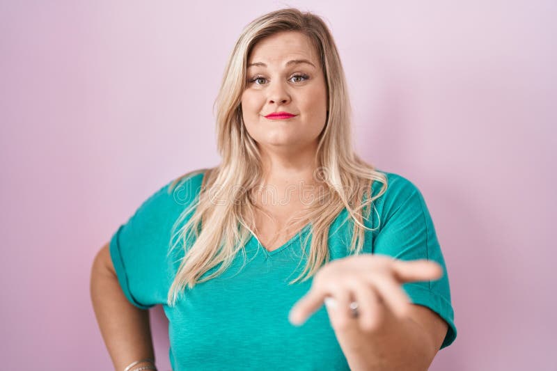 Caucasian Plus Size Woman Standing Over Pink Background Smiling