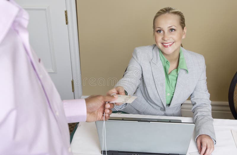 Receptionist Distributing Name Tags Stock Image - Image of colleague ...