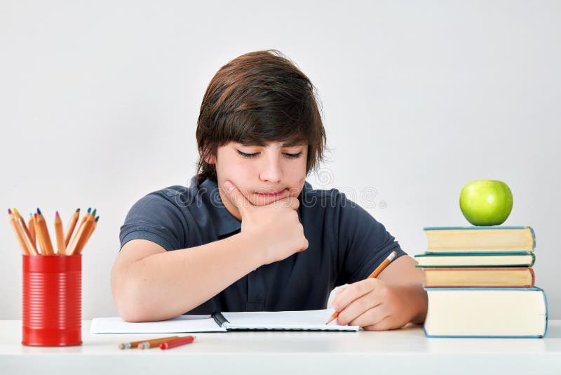 Caucasian School Boy Sit at the Table and Think with a Serious and ...