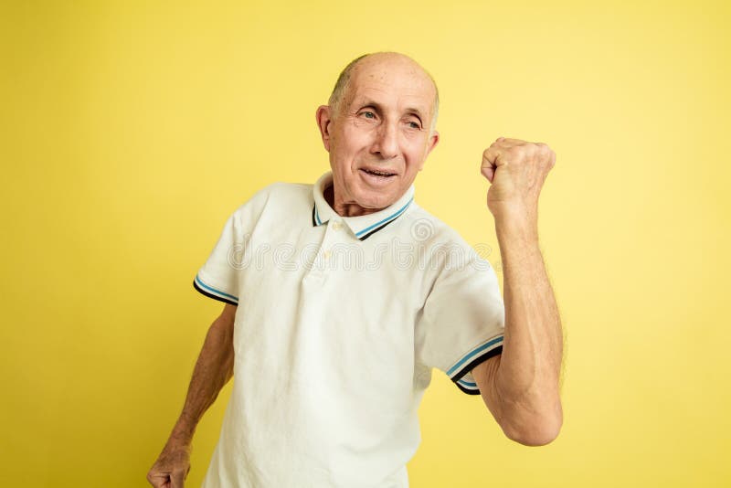 Caucasian Senior Man`s Portrait Isolated on Yellow Studio Background ... Caucasian Senior Man`s Portrait Isolated on Yellow Studio Background ...