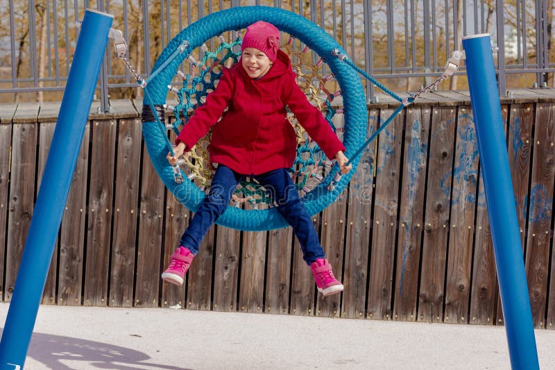 Caucasian Smiling Child of 8 9 Years Swinging on Round Seesaw Looking ...